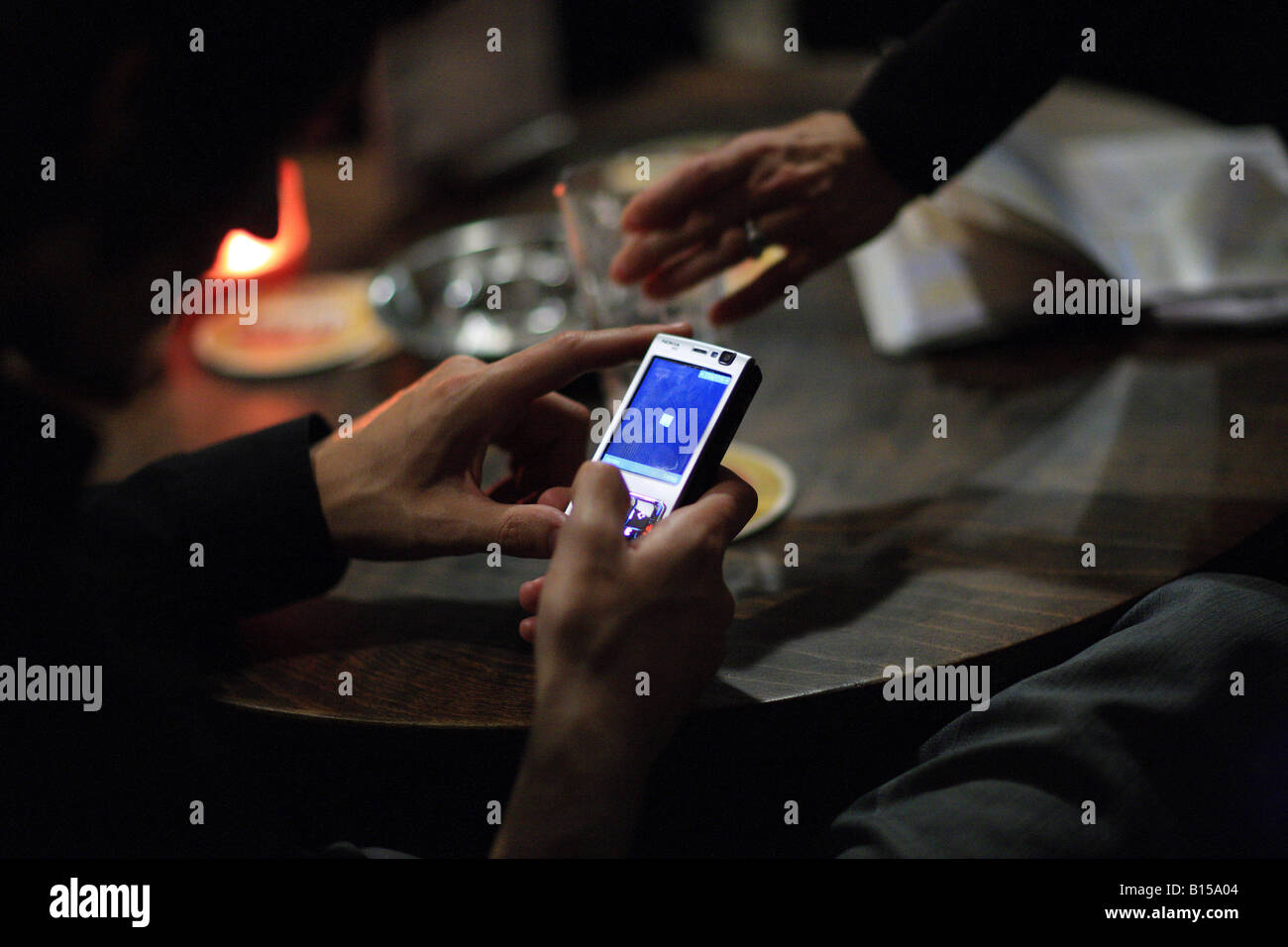 PDA communication device being used in small bar in Amsterdam Stock ...