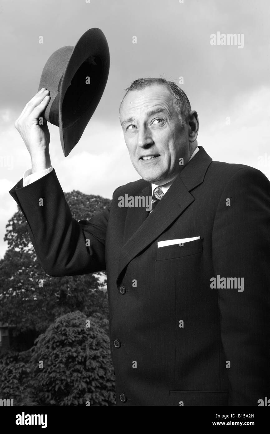 Old fashioned middle aged man raises his hat, black and white 40's 50's ...
