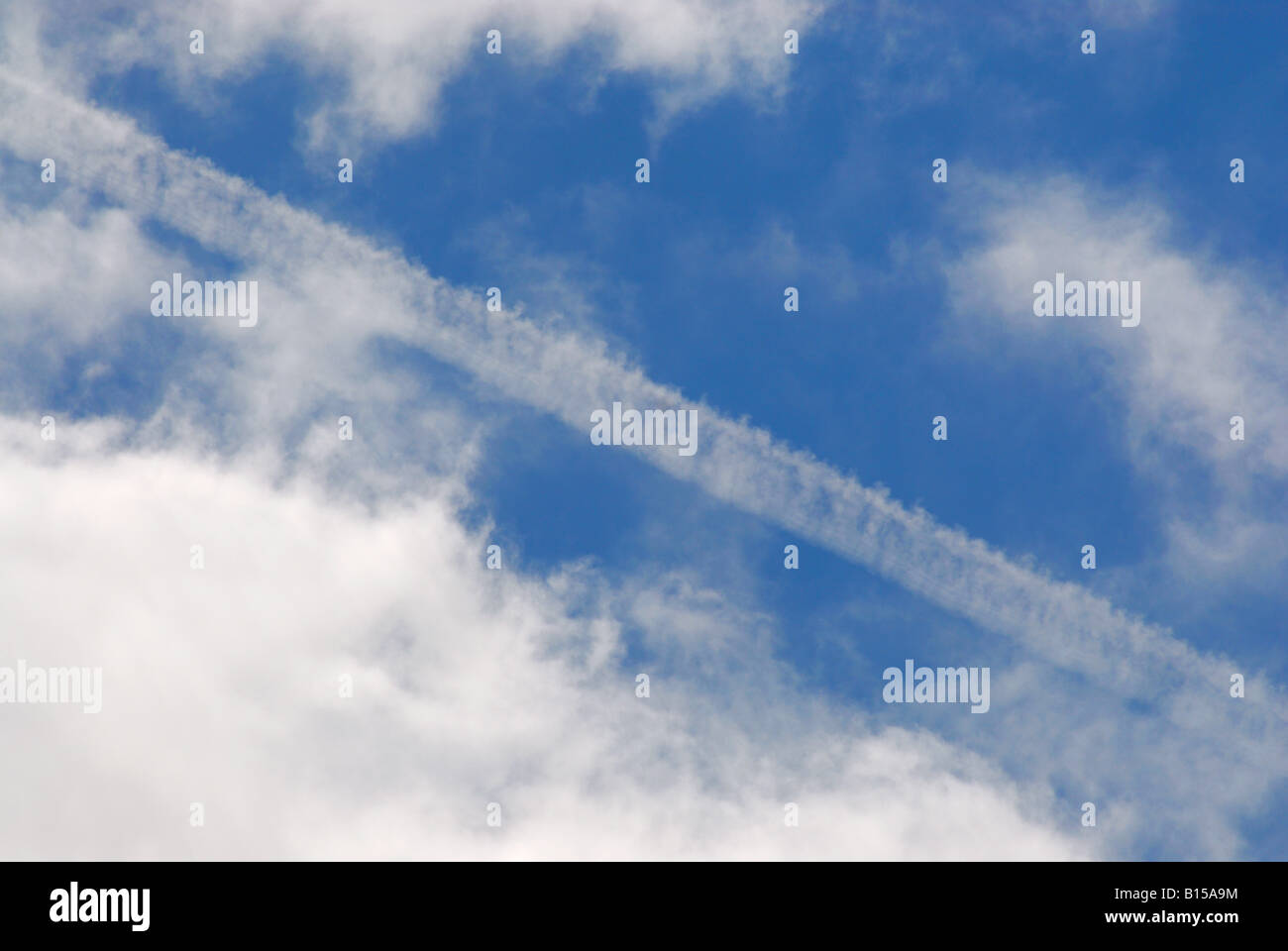 vapor trails or chemtrails from jets in sky often forming grid or ...