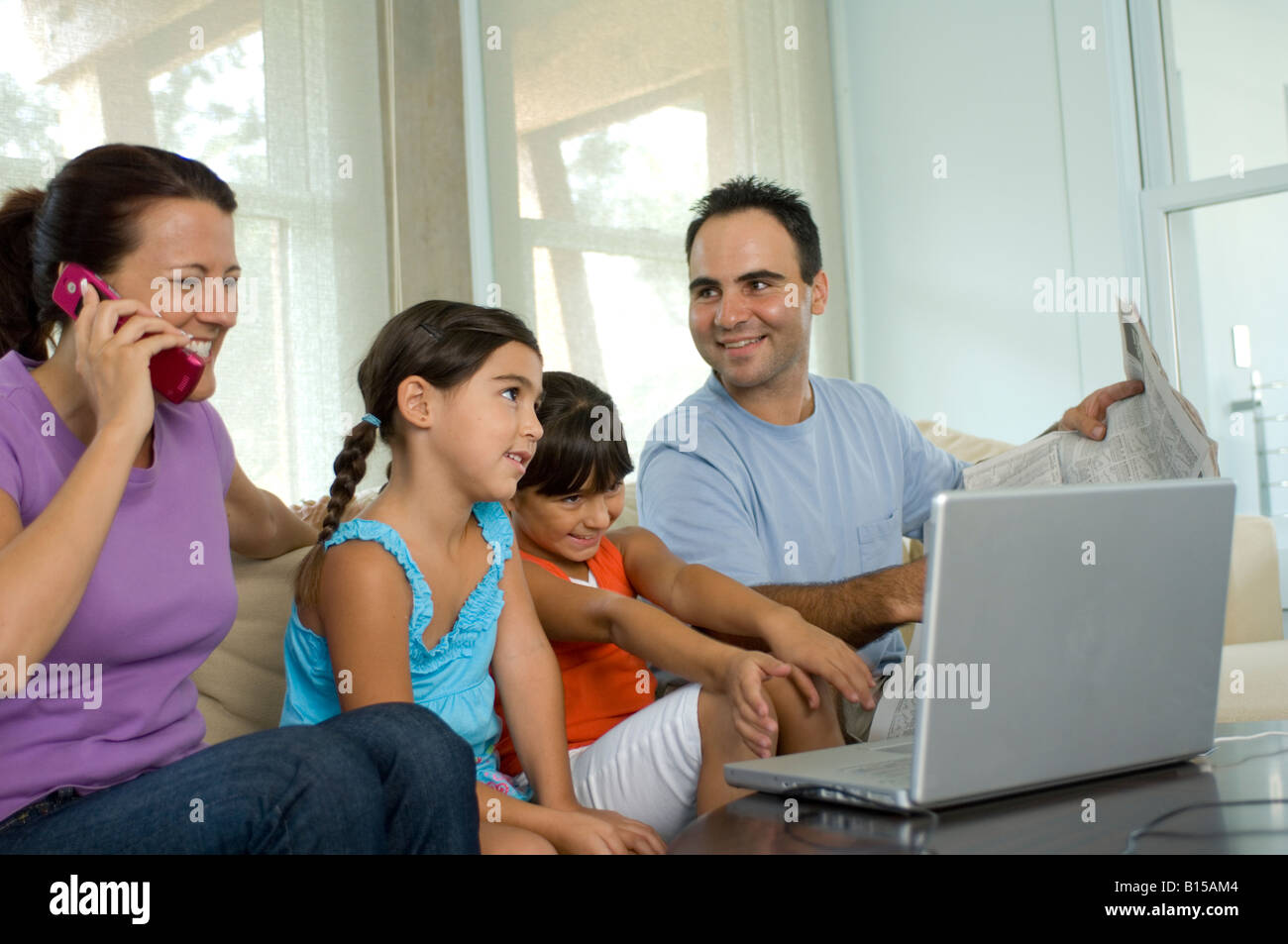 Family with Laptop computer at home Stock Photo - Alamy