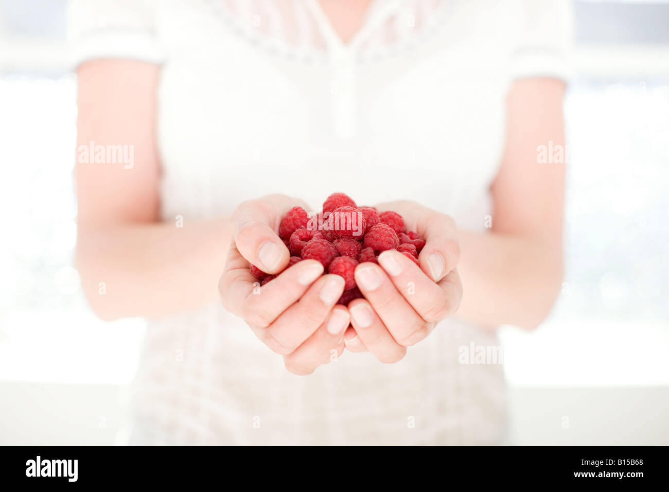 Handful of Raspberries Stock Photo - Alamy