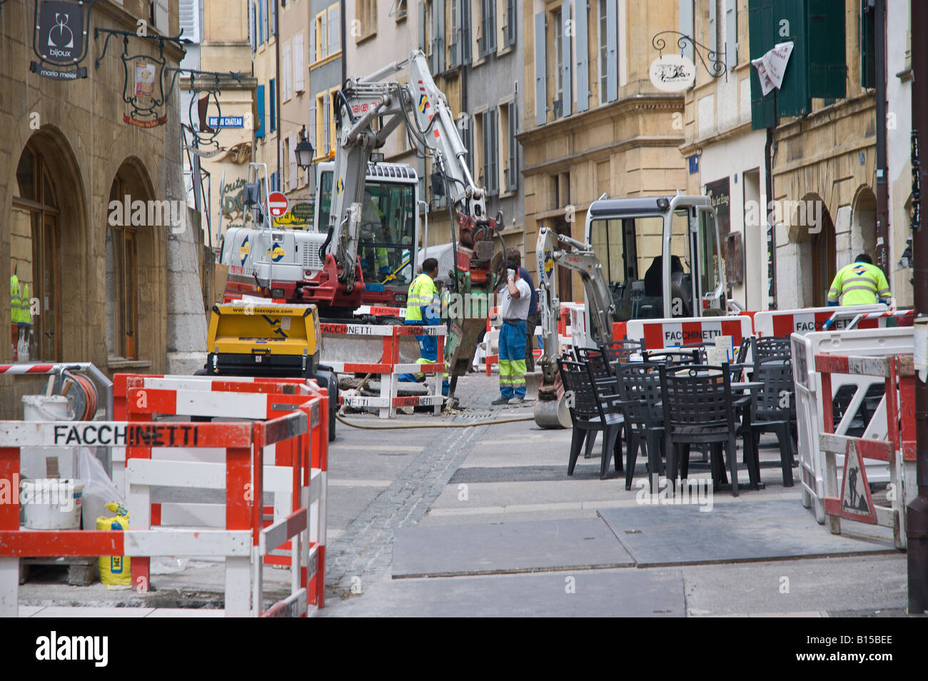 Construction equipement and barriers line the street during a ...