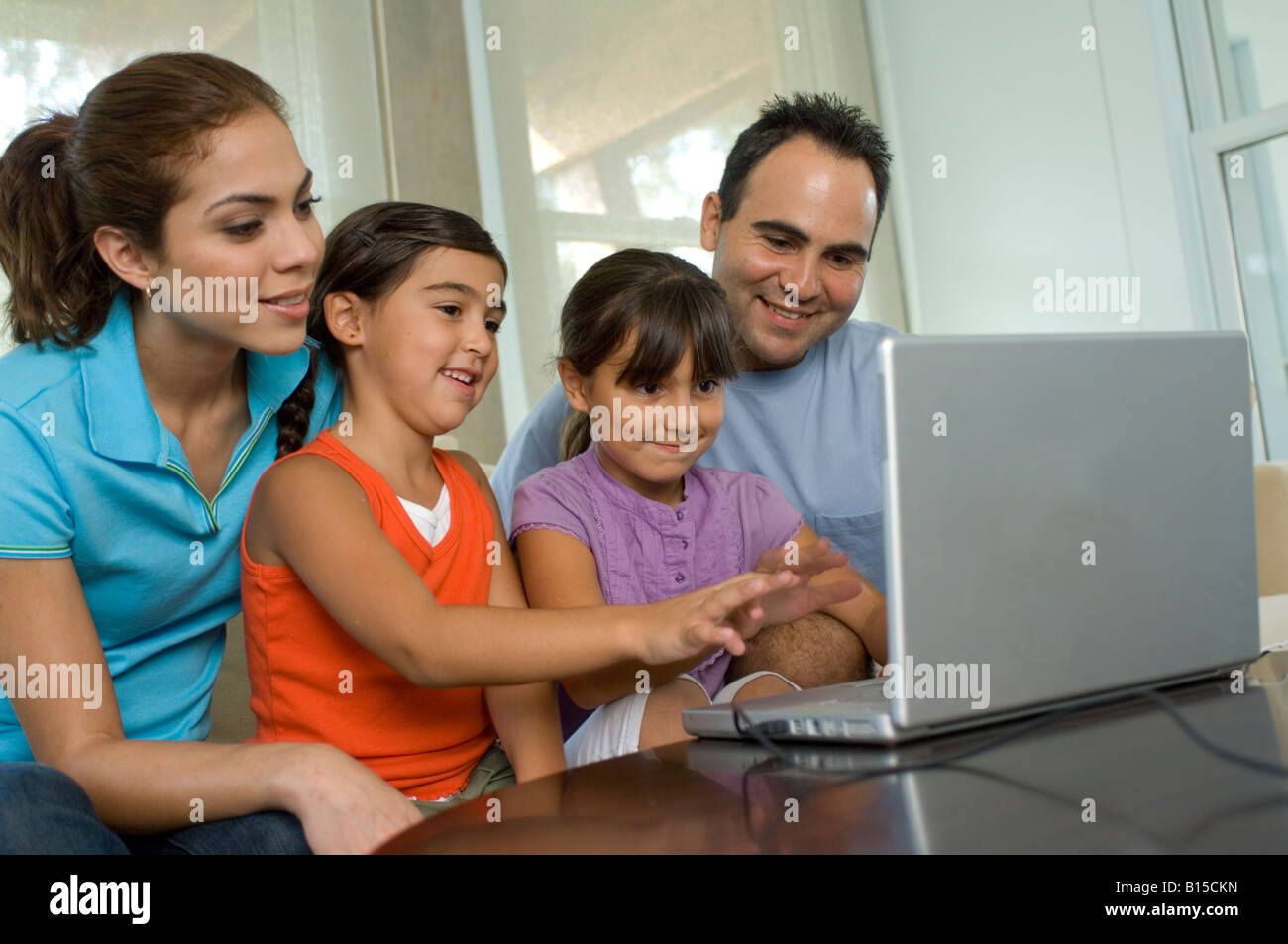 Family with Laptop computer online Stock Photo - Alamy
