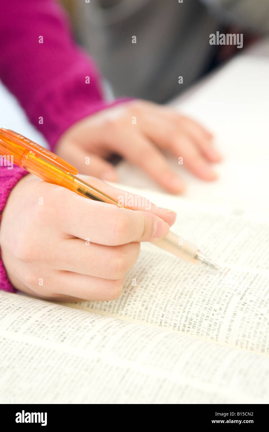 Hand referring to a dictionary Stock Photo - Alamy