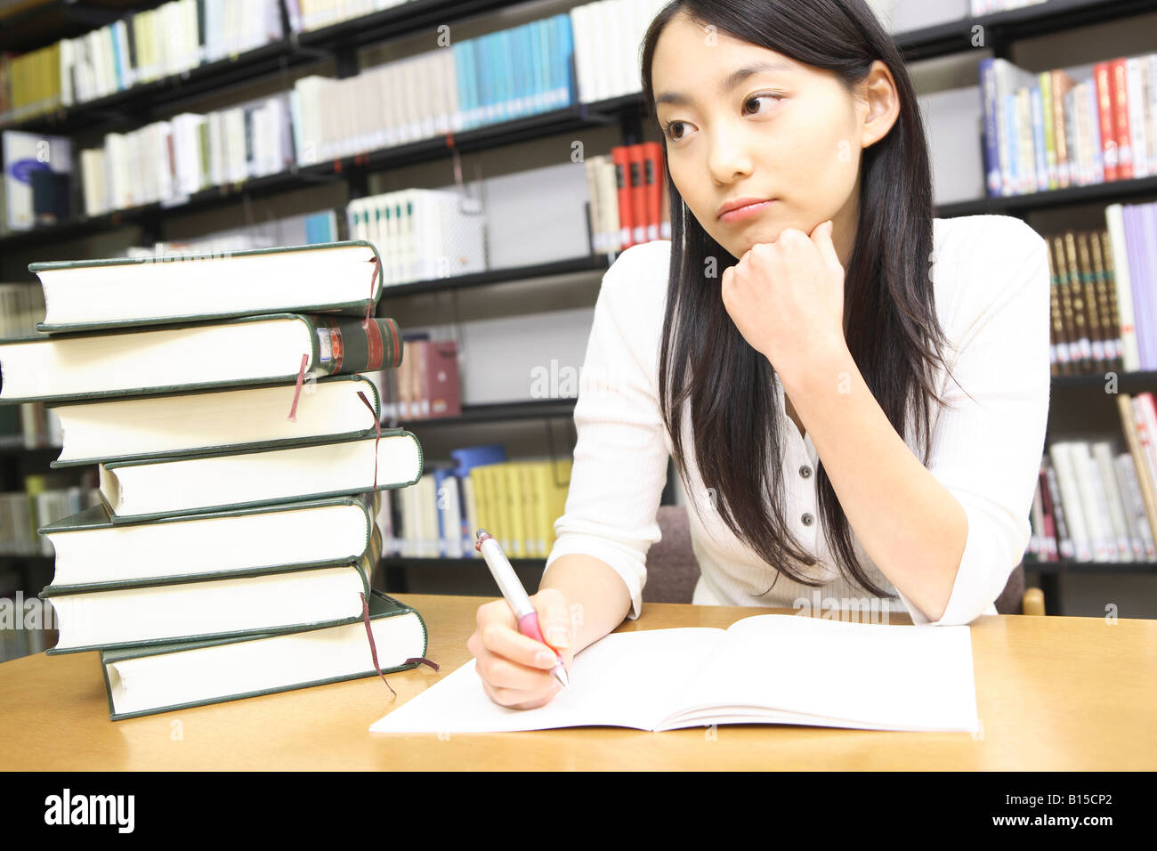 Japanese student studying in library Stock Photo - Alamy