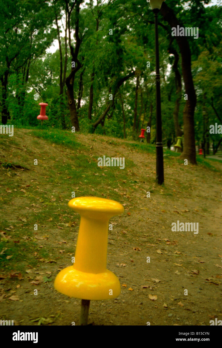 Yellow drawing pin stacked in the soil Stock Photo - Alamy