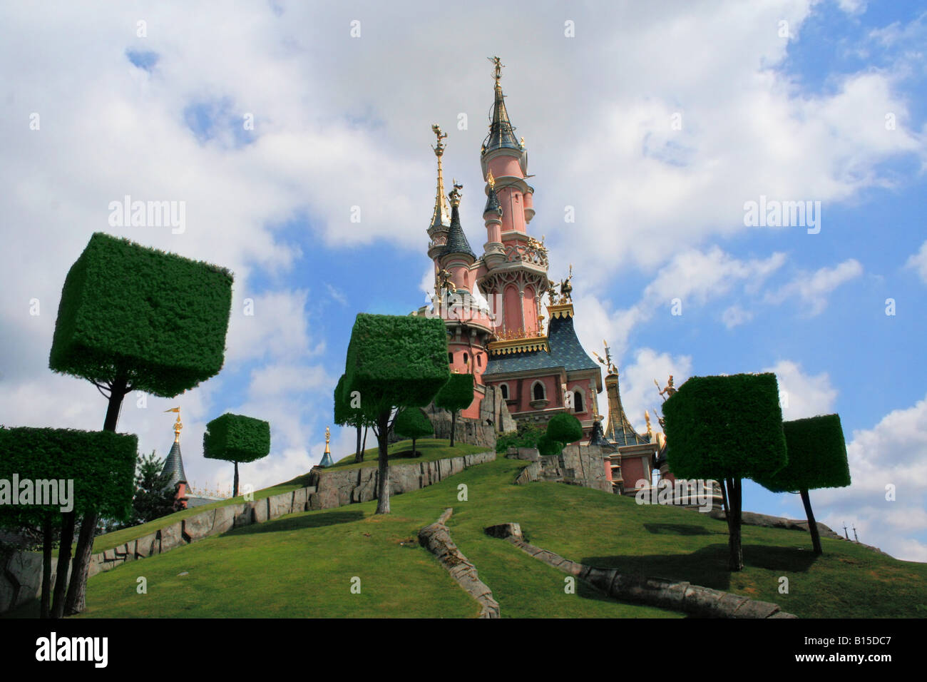 Disneyland castle on a hill with a trimmed trees Stock Photo - Alamy