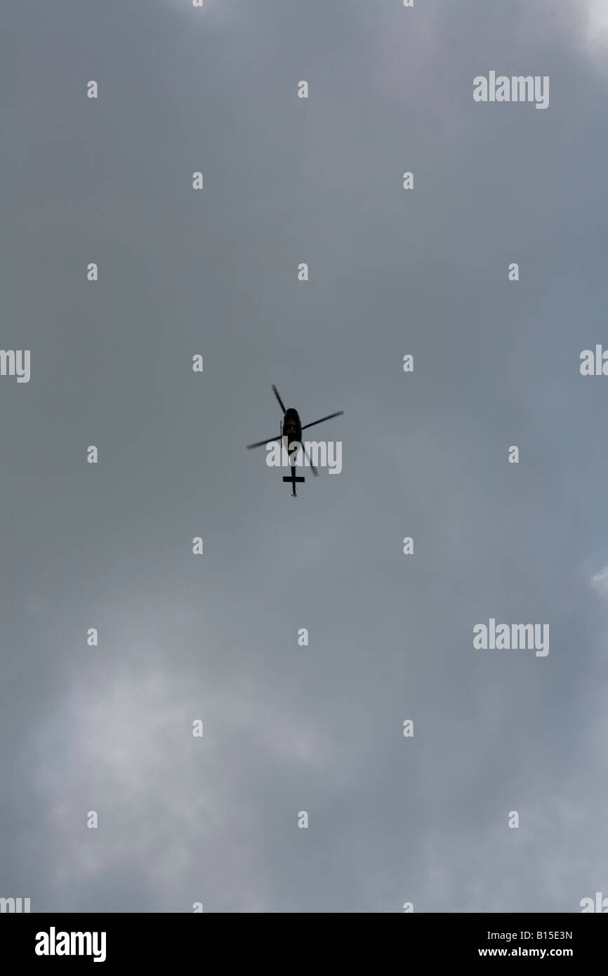 helicopter flying overhead with storm clouds as a backdrop above Stock ...