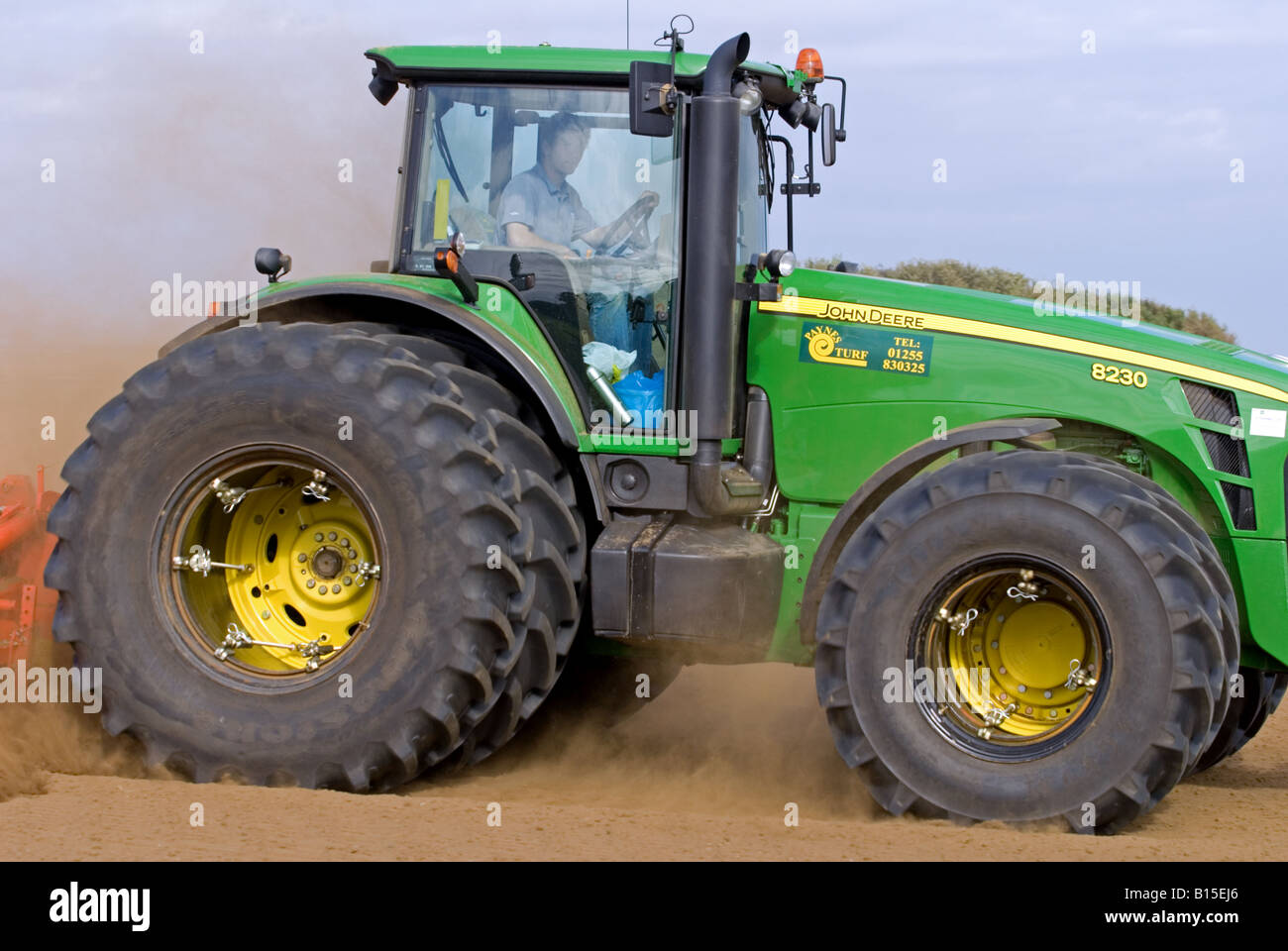 John Deere 8230 tractor in use on a farm in Bawdsey, Suffolk, UK Stock ...