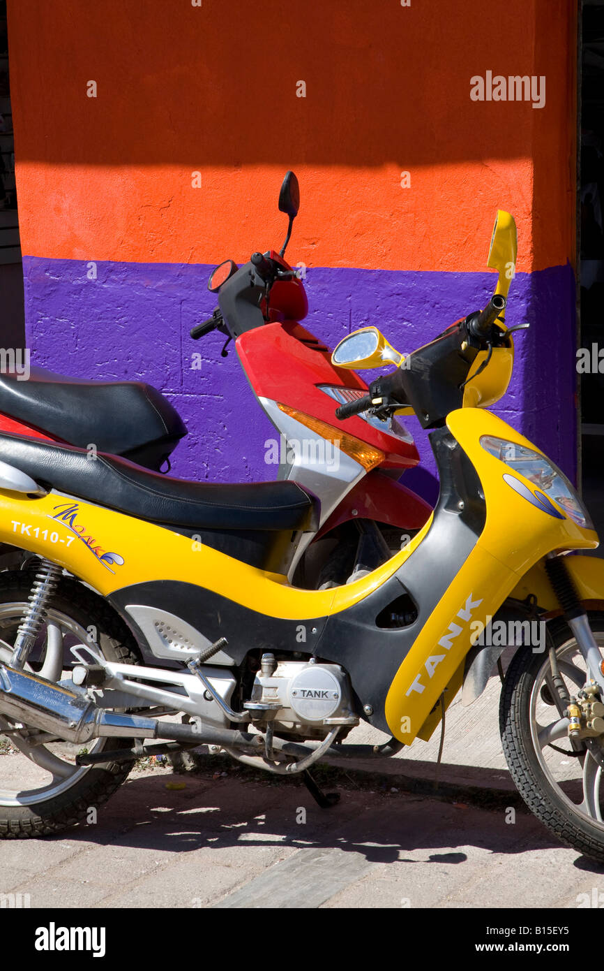 Colourful scooters outside painted shop in Ticul Mexico Stock Photo - Alamy