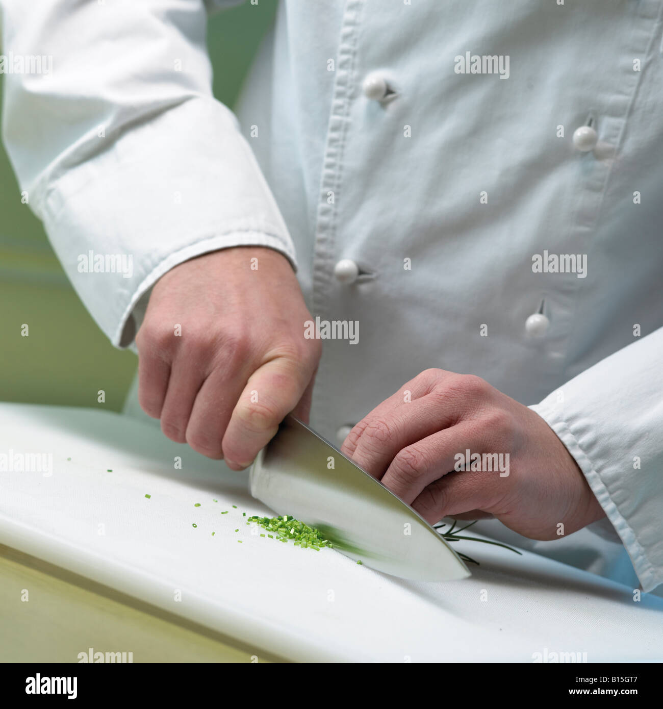 cook is cutting parsley close up hands and knife Stock Photo - Alamy