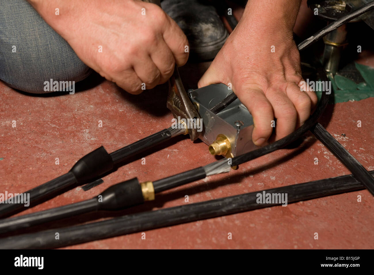 A cable is secured into a metal juntion box Stock Photo - Alamy