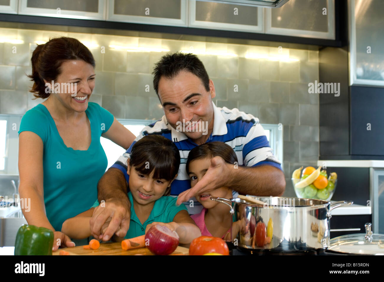 Family cooking together at home Stock Photo - Alamy