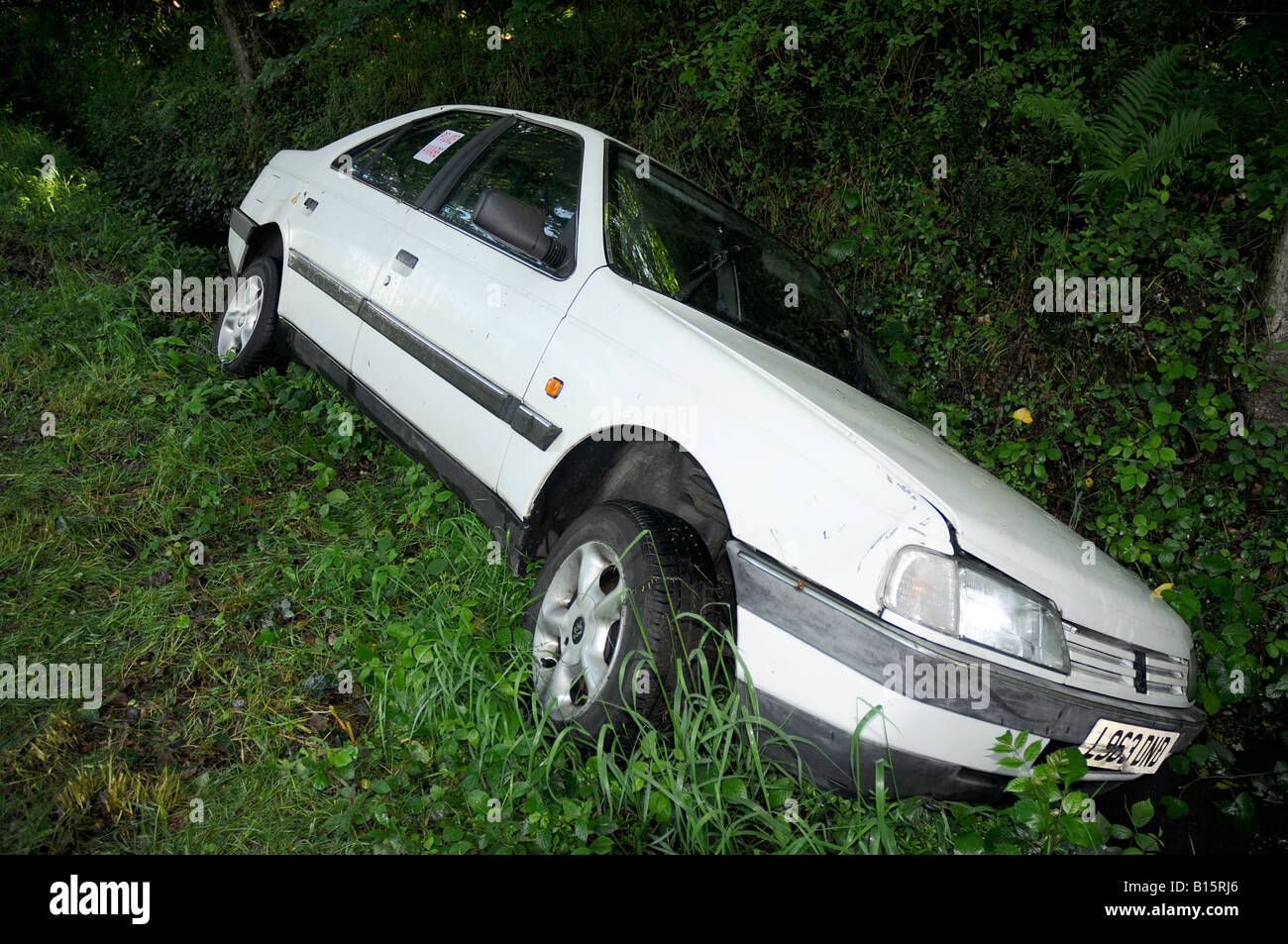 Peugeot 405 lying in a ditch with Police Aware sticker on side window ...