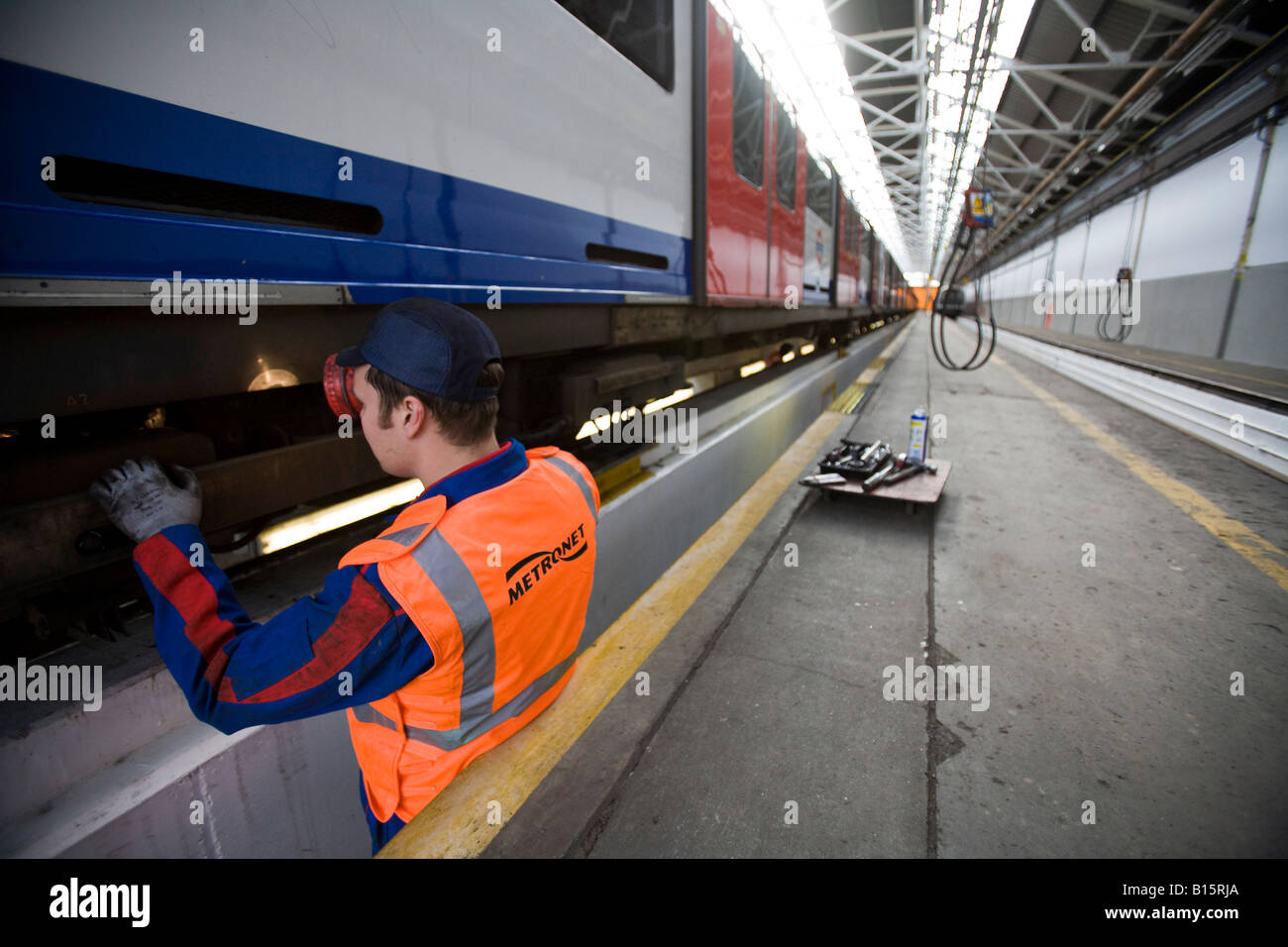 A Metronet engineer works on maintaining tube trains at Hainault depot ...