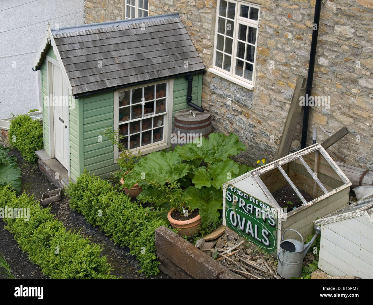 A traditional wooden garden shed and cold frames in Richmond North ...