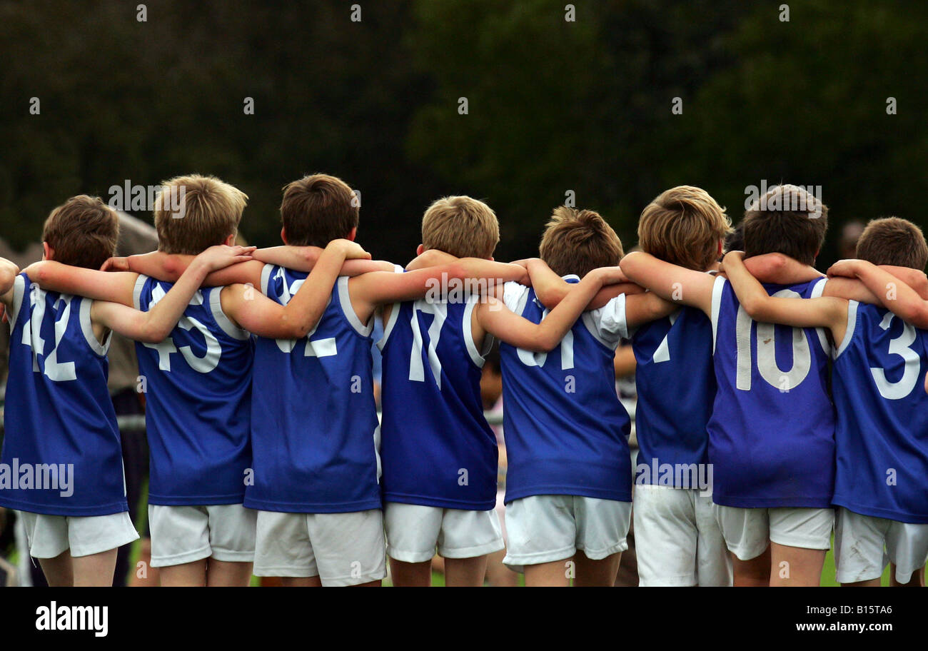 Children celebrate a win after playing an Aussie Rules football match ...