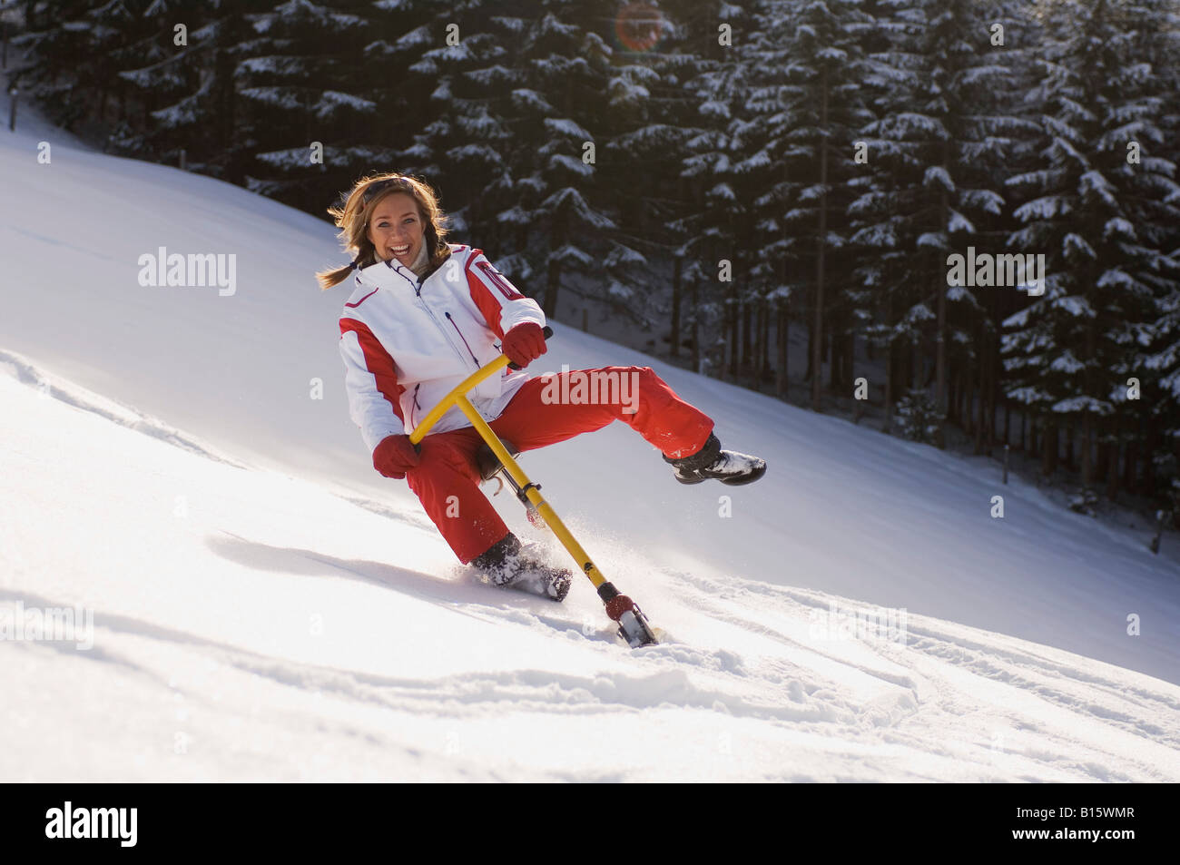 Austria, Altenmarkt, Young woman on snow wing scooter Stock Photo - Alamy