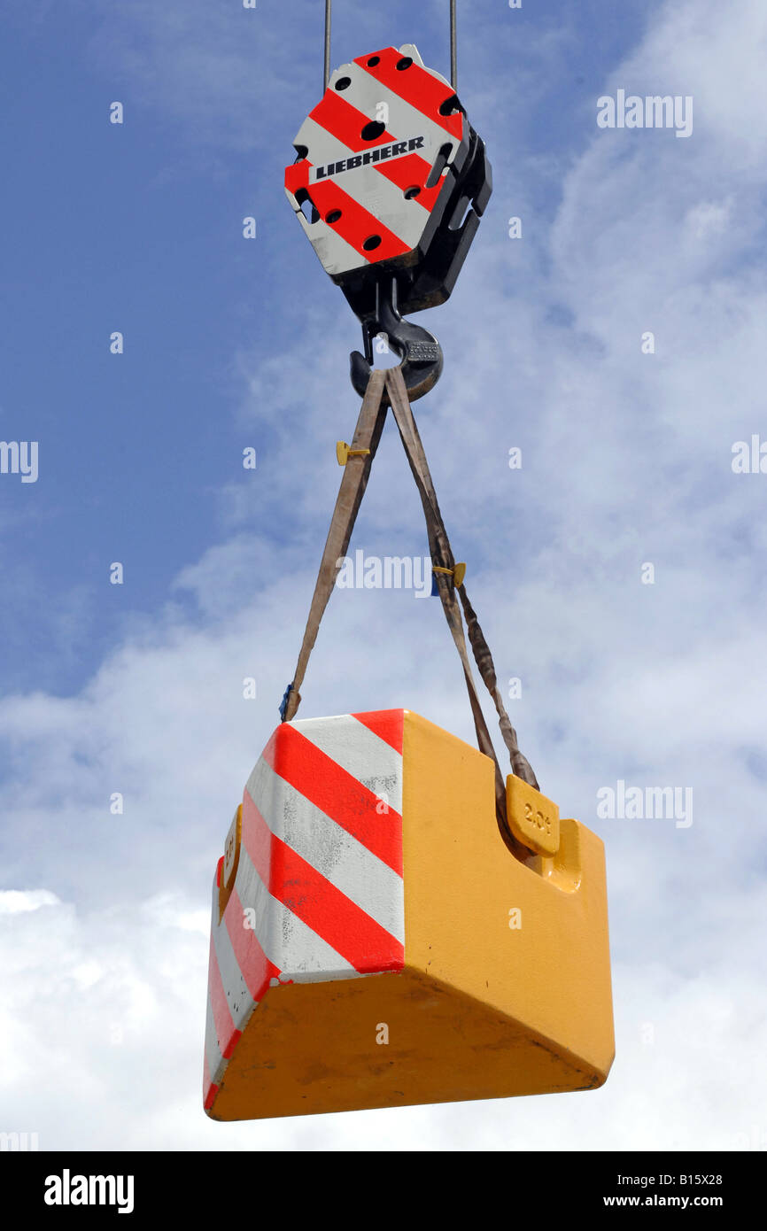 Two ton counter weights for a mobile crane being lifted into place ...