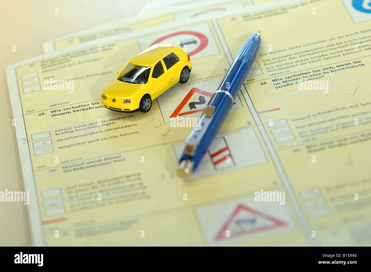 Pen and toy car on driving licence test form Stock Photo - Alamy