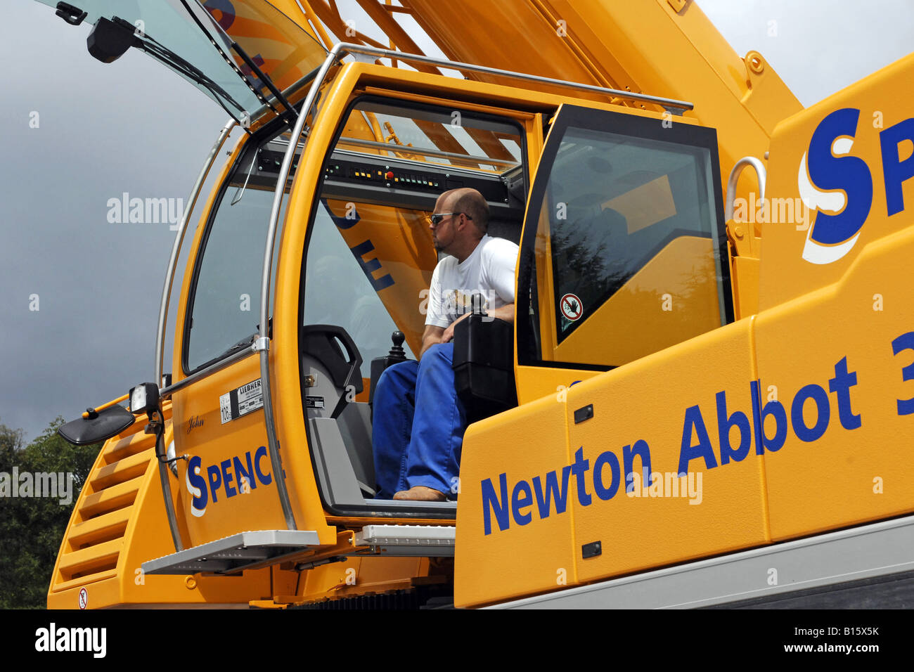 The crane driver in his digitalized cab where a computer system ...