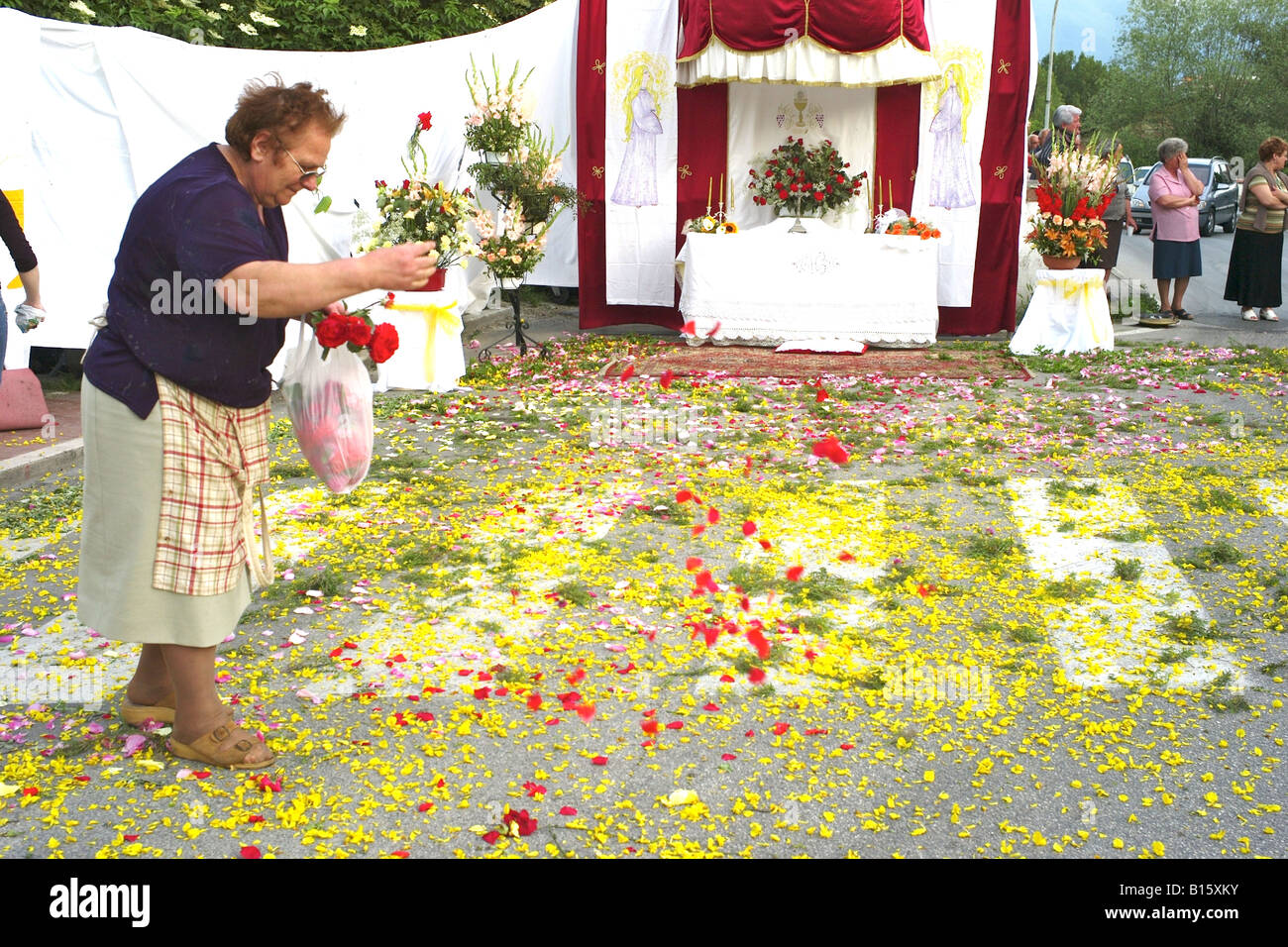 Woman putting flower in the street in italy Stock Photo - Alamy