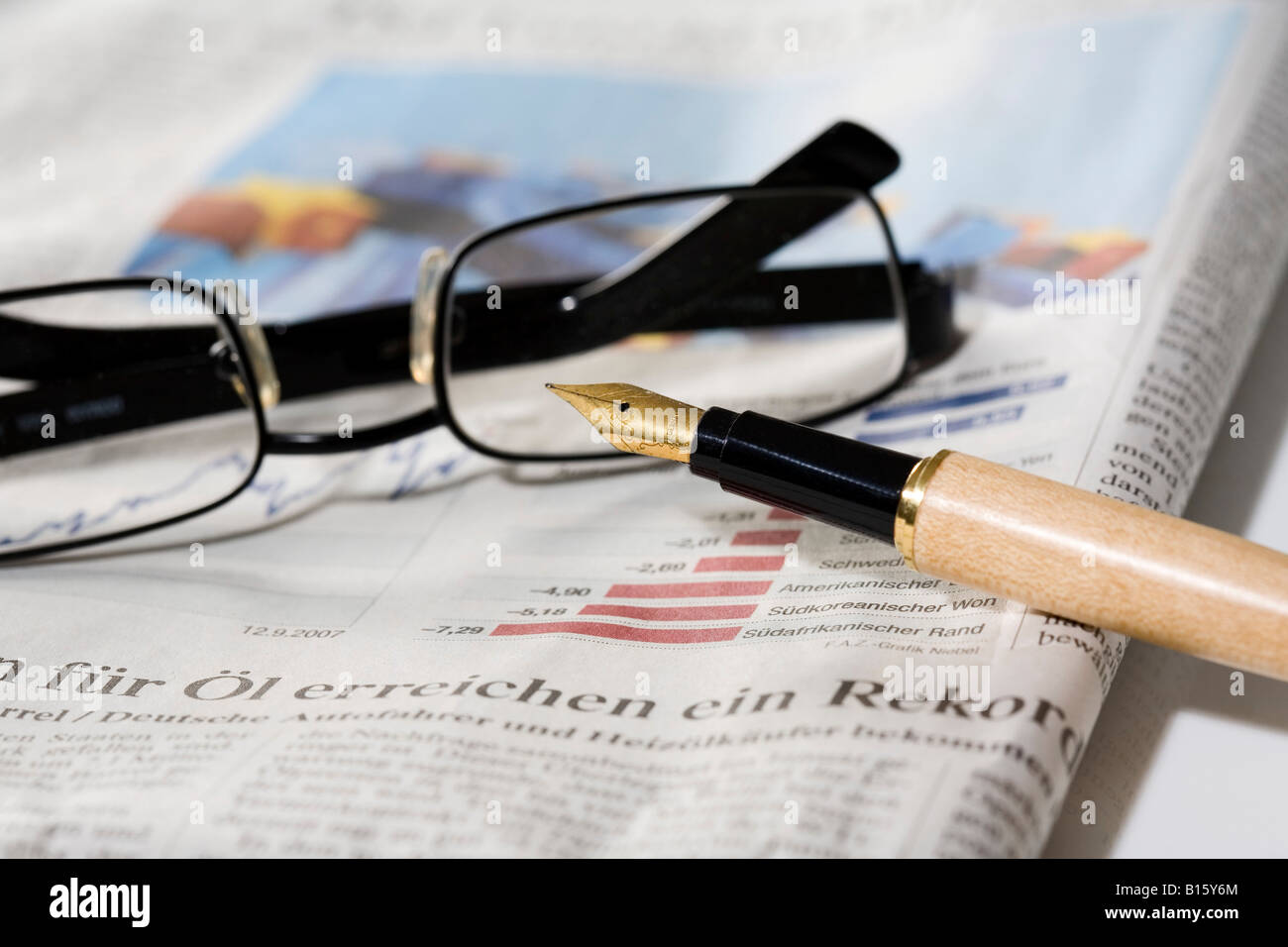 Pen and spectacles on newspaper, close-up Stock Photo - Alamy