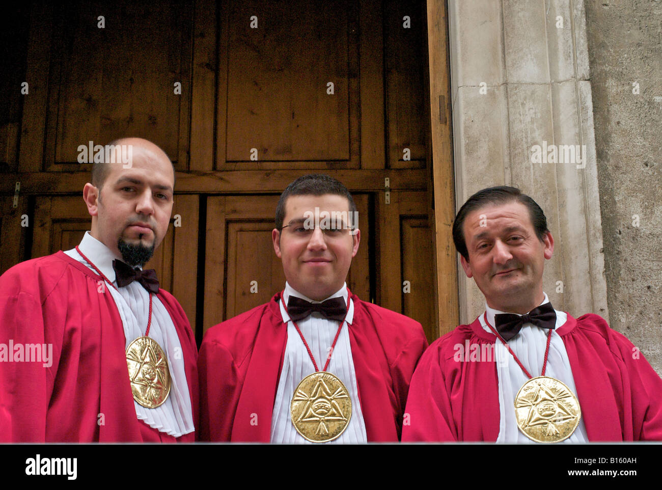 three person outside of a church dressed in italian religion dress ...