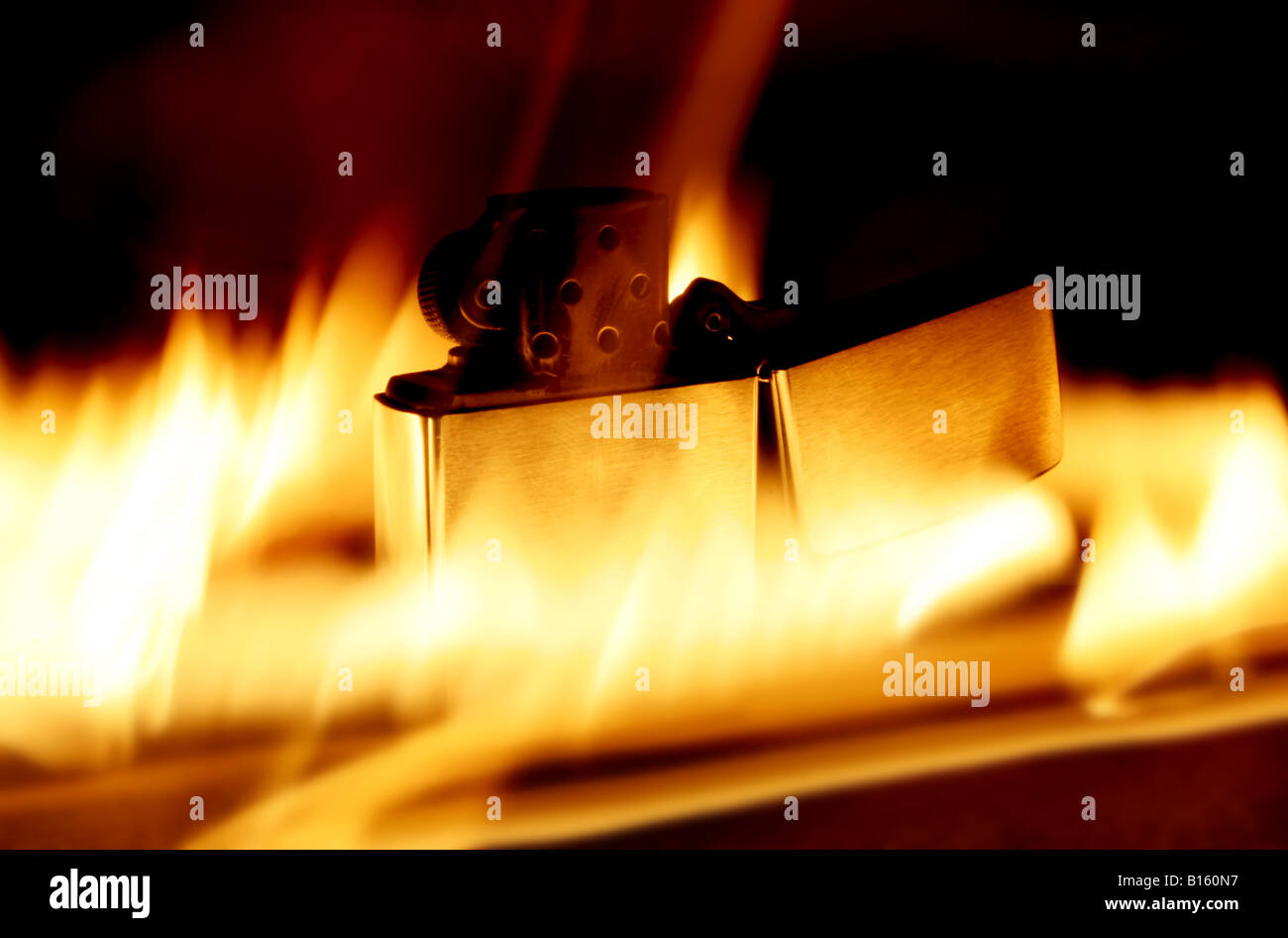 burning lighter with flames all around it Stock Photo - Alamy