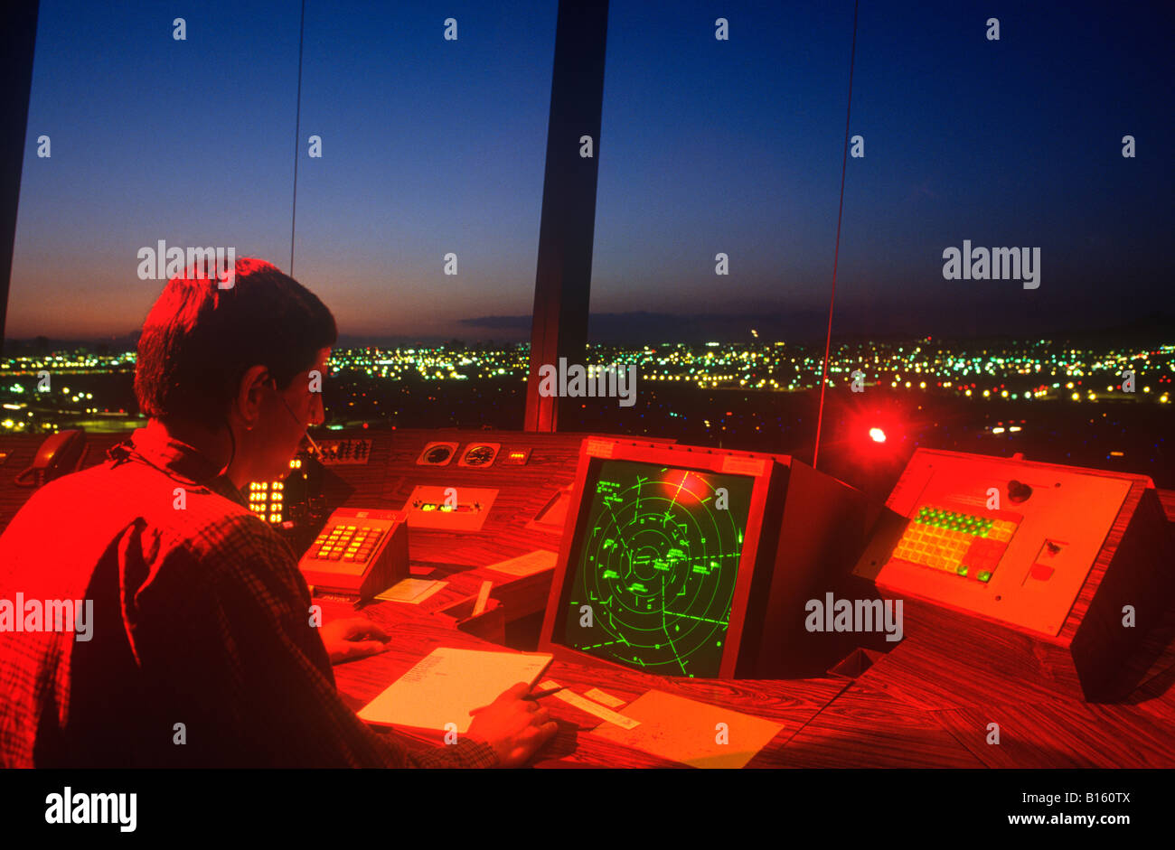 An air traffic controller monitors the screen at an airport Stock Photo ...