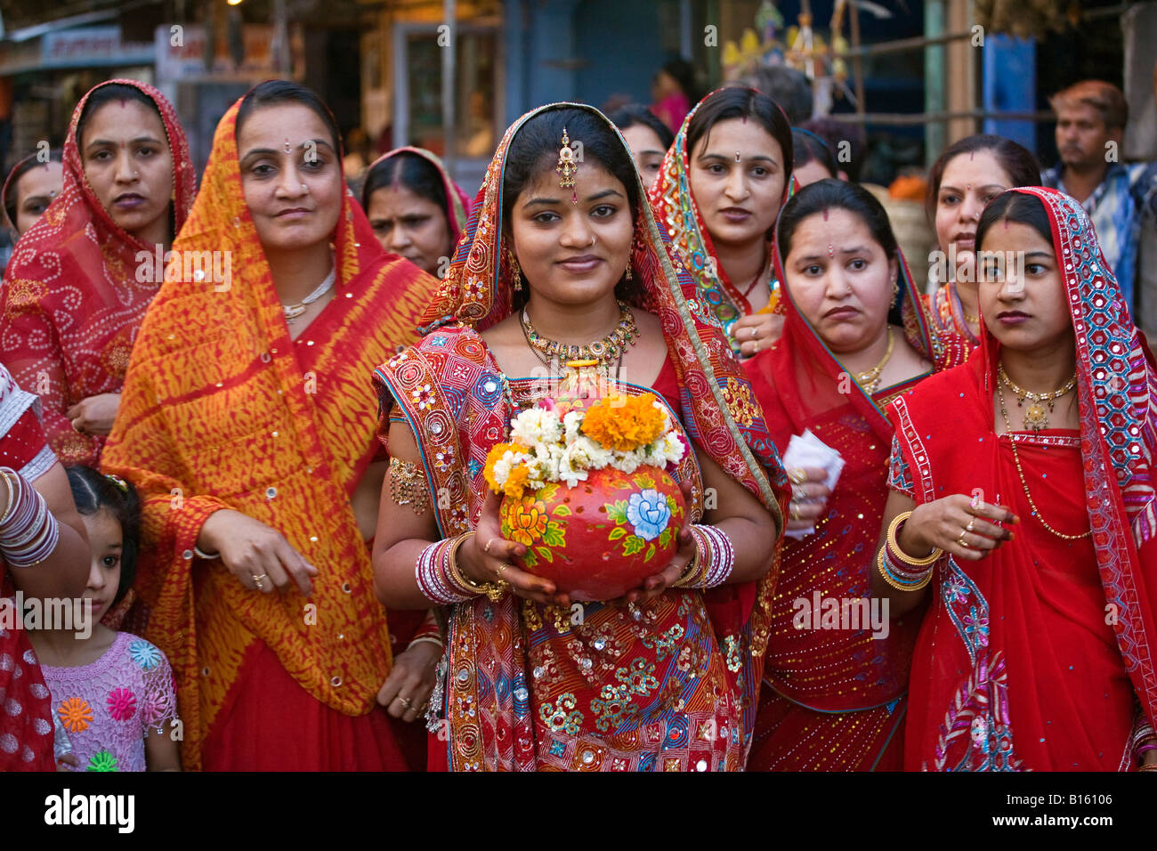 Rajasthani women carry a clay pot through the city as part of the ...