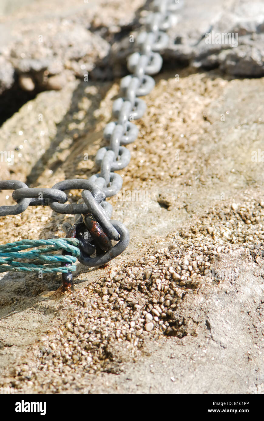 A chain on the stone of the Mediterranean seacoast Stock Photo - Alamy