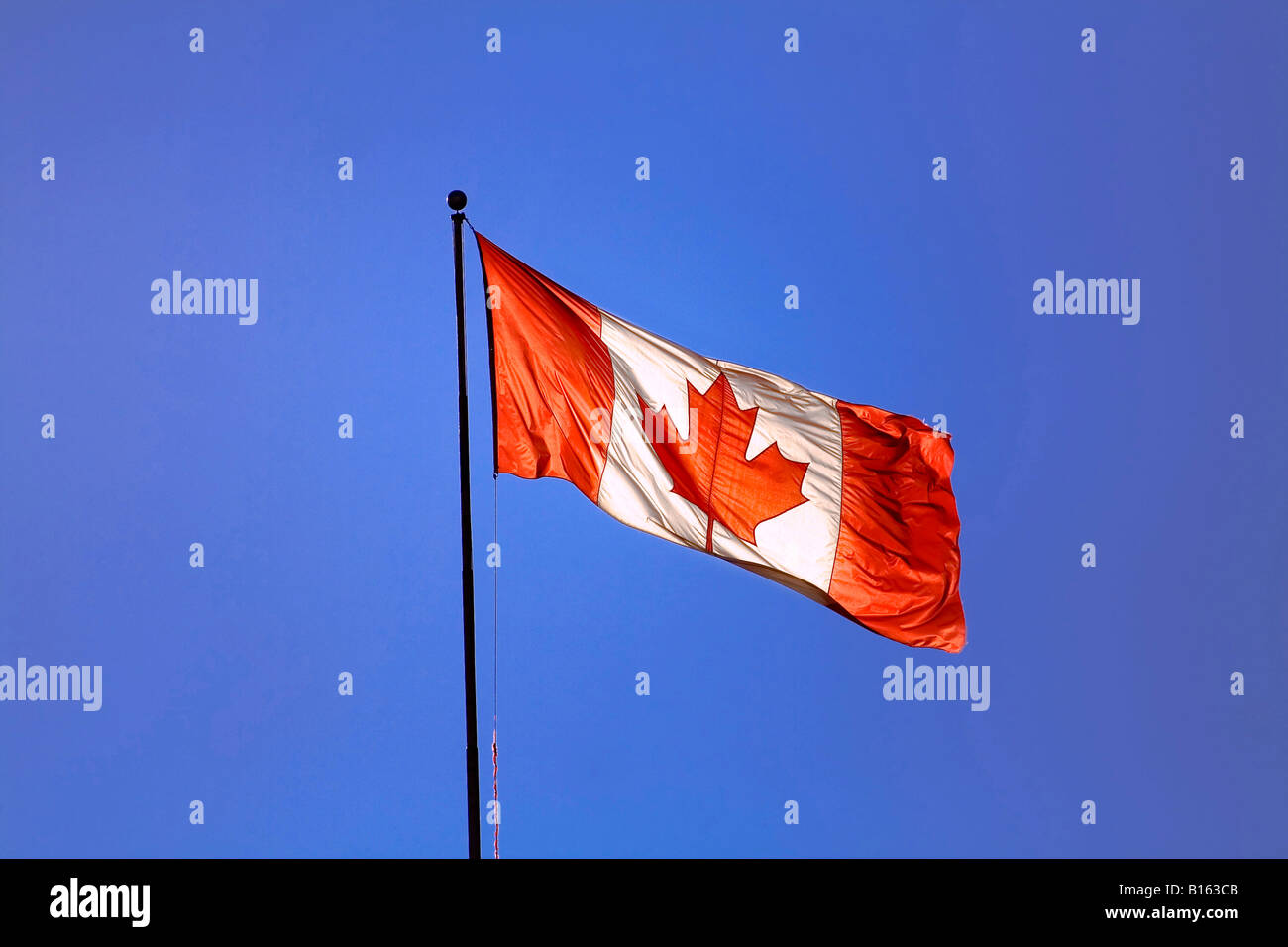 Canadian flag blue sky Stock Photo - Alamy