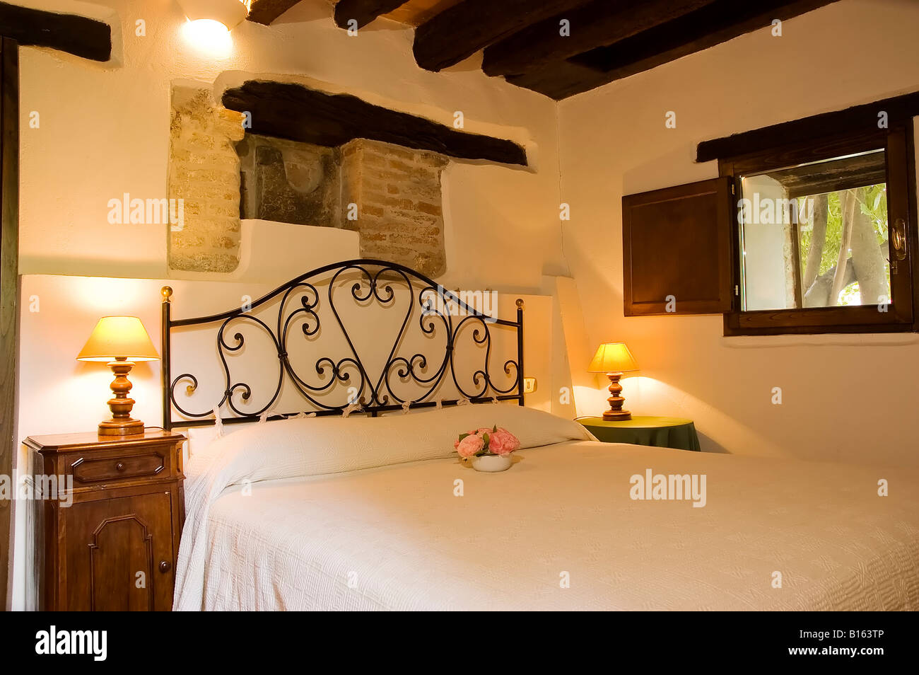 Double bed in a rustic hotel room with wooden beams in the ceiling ...