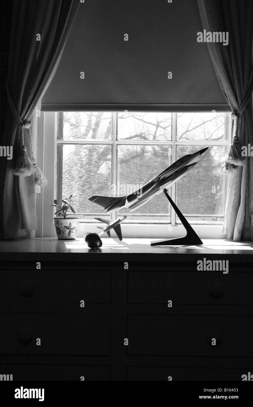 A window sill with a model airplane Stock Photo - Alamy