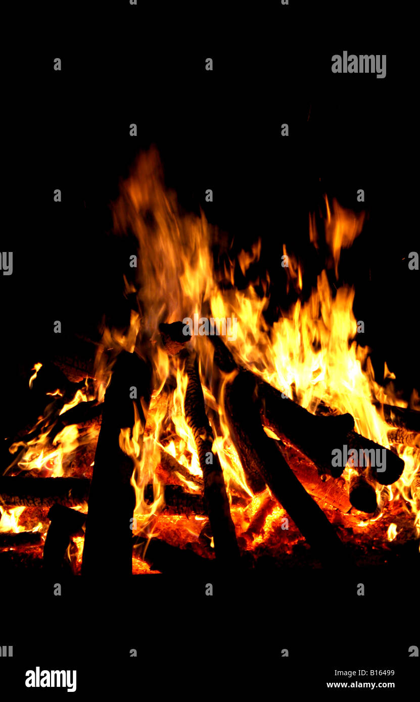 burning log wood with black background Stock Photo - Alamy