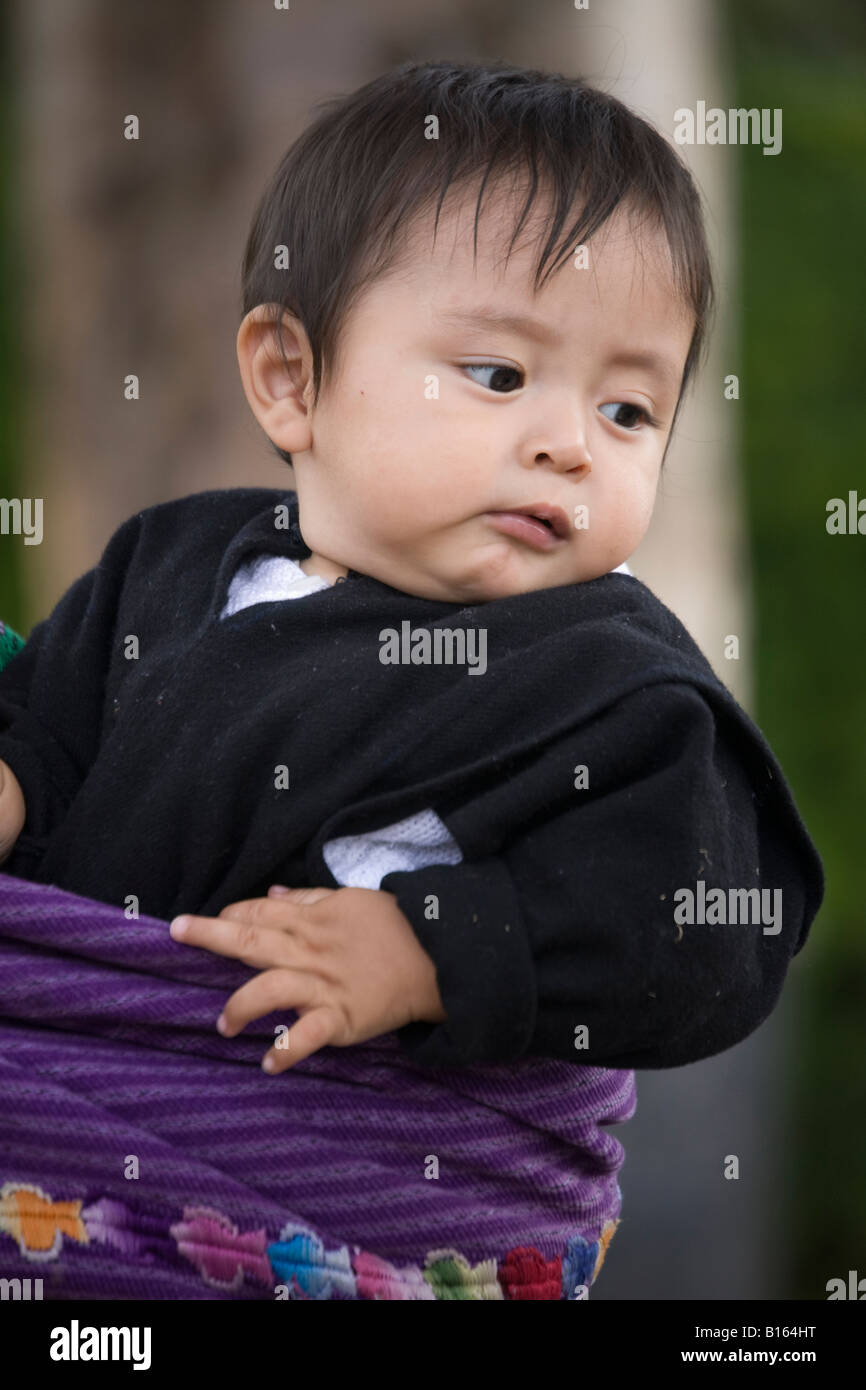 An Mayan baby being carried in a sling Stock Photo - Alamy