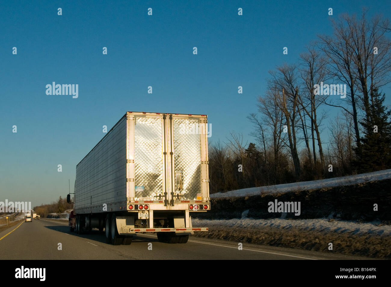 A transport frieght truck hauling a load along a busy highway Stock ...