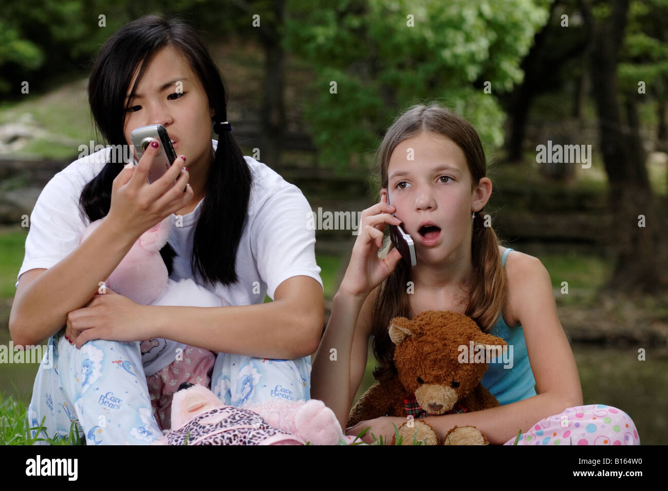 Stock Photograph of two girls talking on cell phones Stock Photo - Alamy
