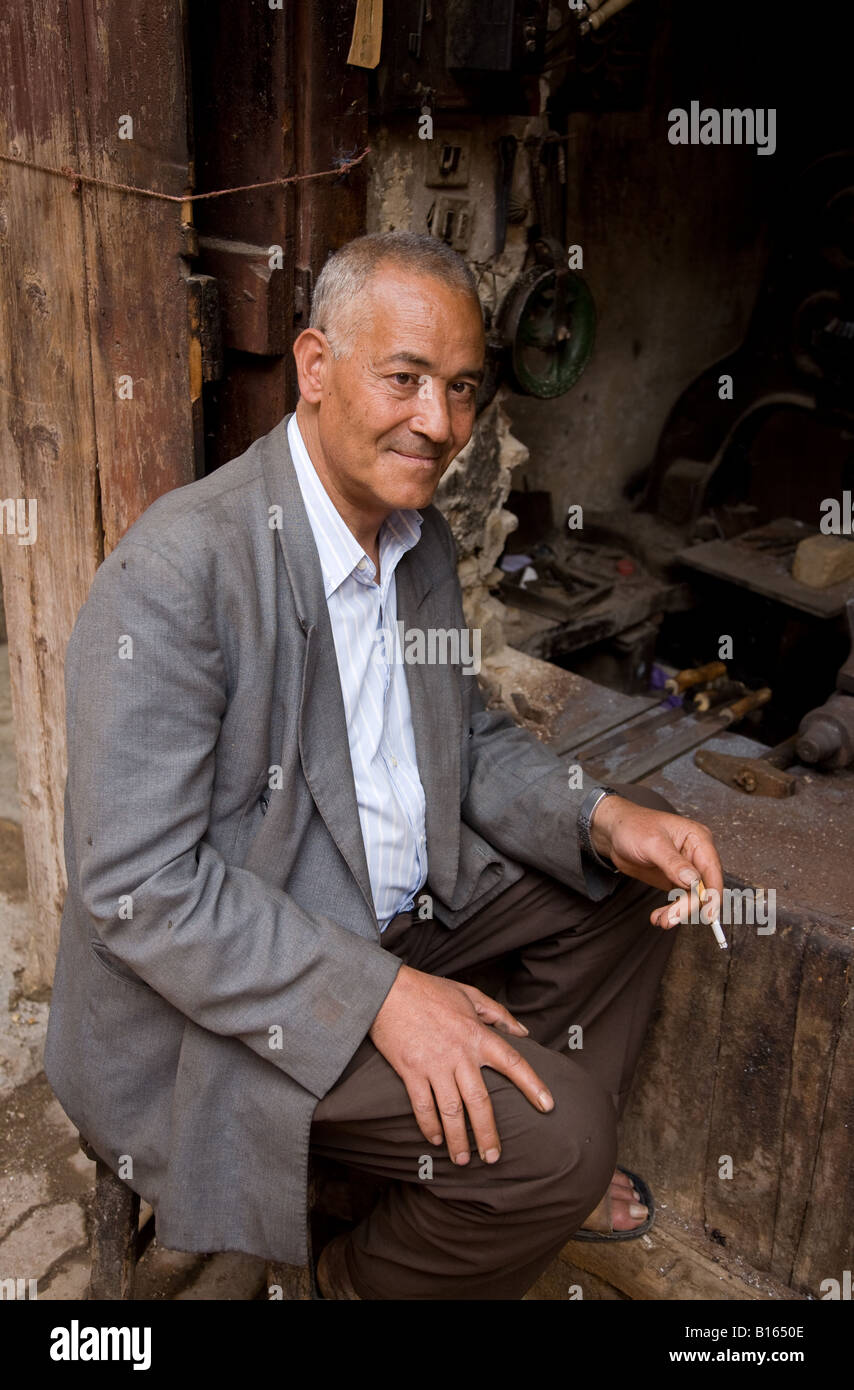 Portrait of mansitting down ,smoking in Fez Morrocco Stock Photo - Alamy