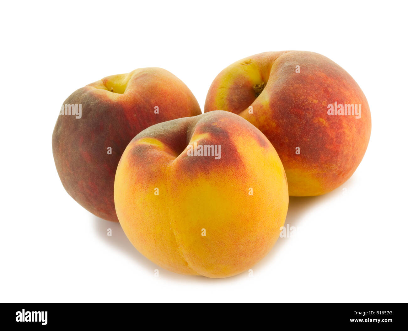 three full peaches isolated on white background Stock Photo - Alamy
