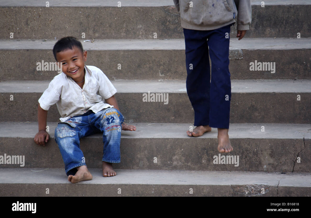 Laos Children waiting on steps Stock Photo - Alamy