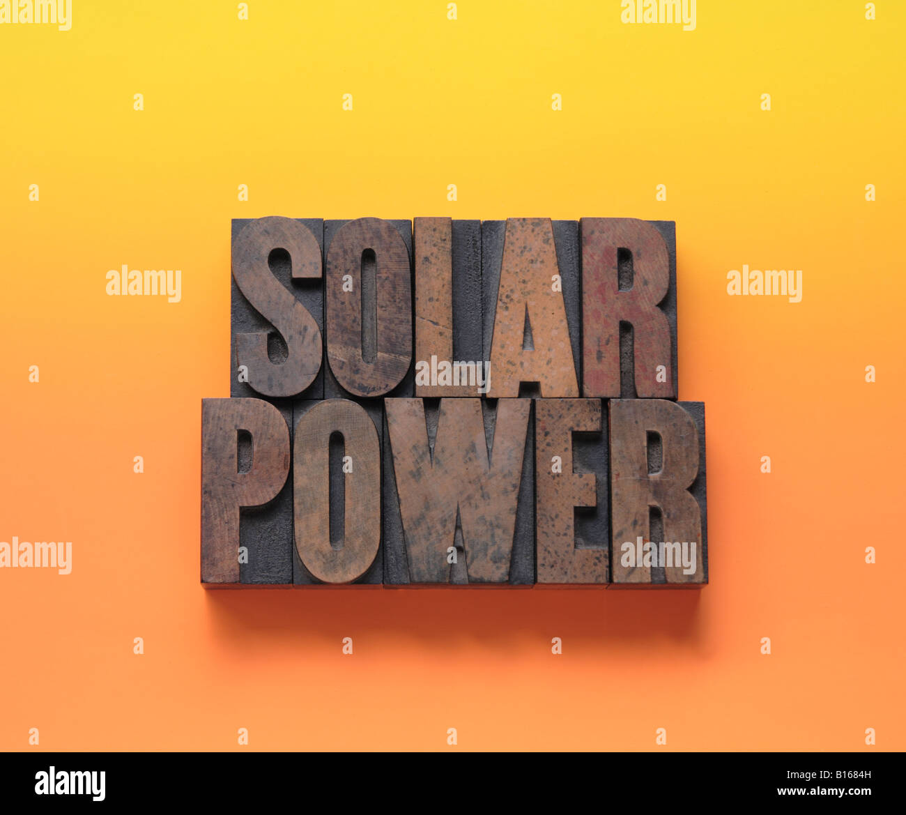 the phrase 'solar power' in letterpress wood type on a yellow and ...