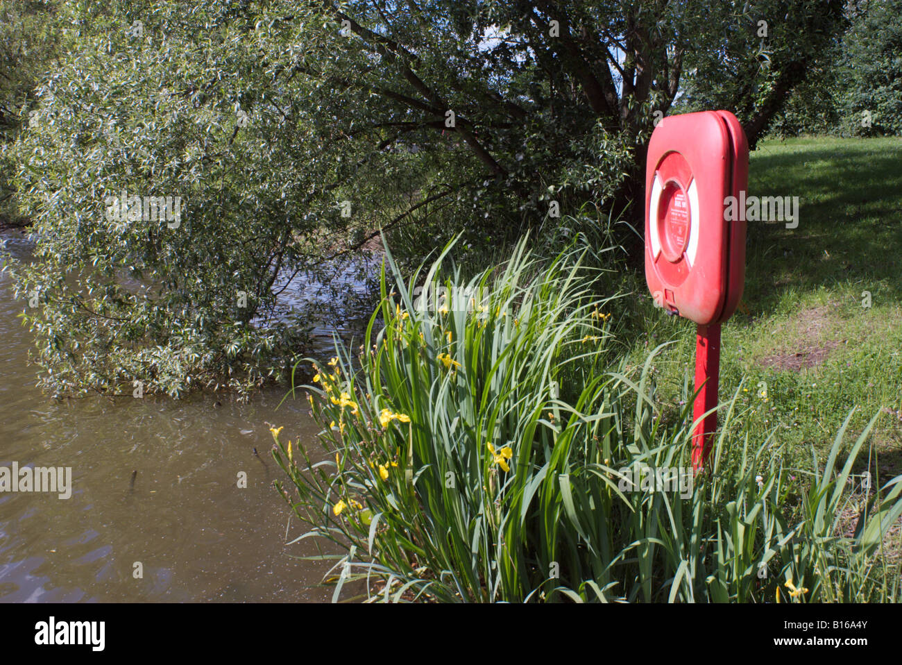 Red life belt by the man-made lake in suburban Goldsworth Park Woking ...