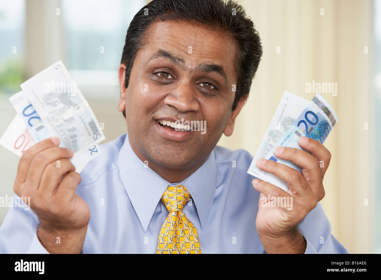 Middle Eastern man holding money Stock Photo - Alamy