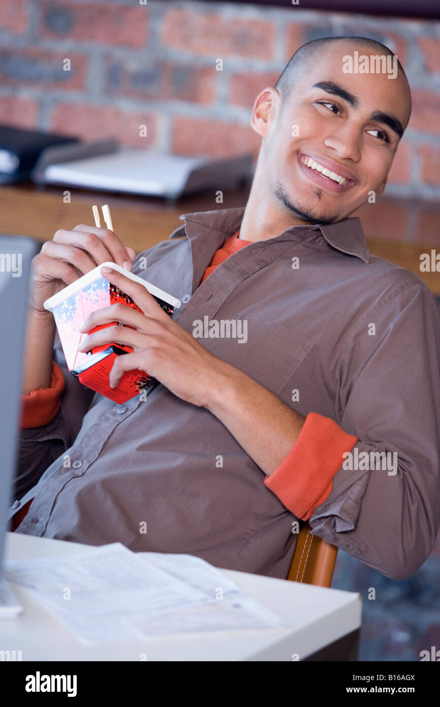 African American man eating take out food Stock Photo - Alamy