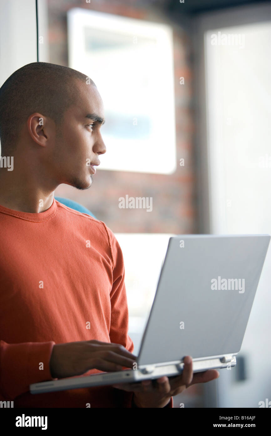African American man holding laptop Stock Photo - Alamy
