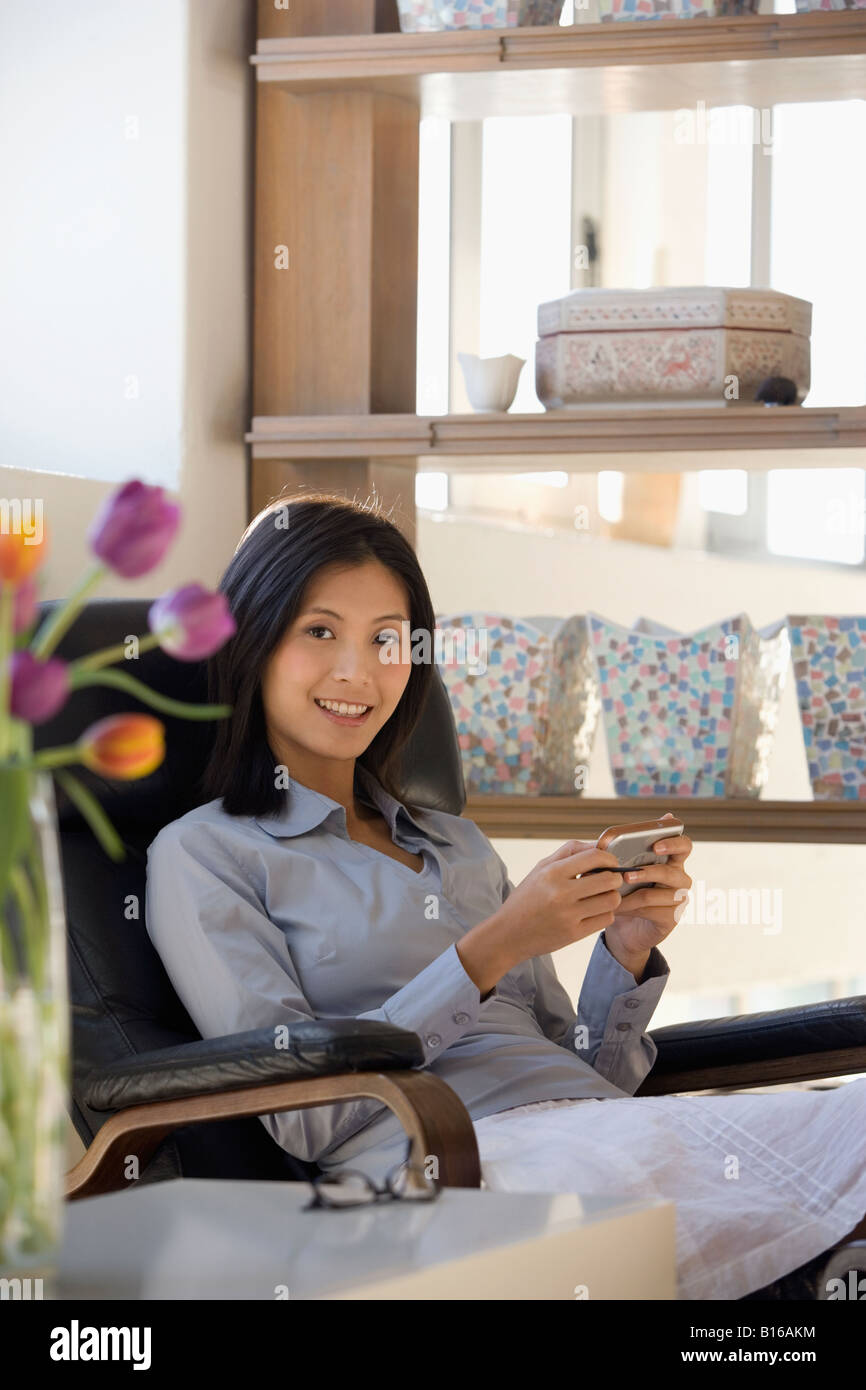Asian businesswoman holding electronic organizer Stock Photo - Alamy