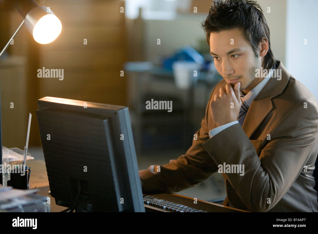 Asian businessman looking computer hi-res stock photography and images ...