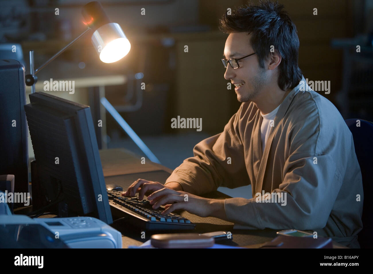 Asian businessman typing on computer Stock Photo - Alamy